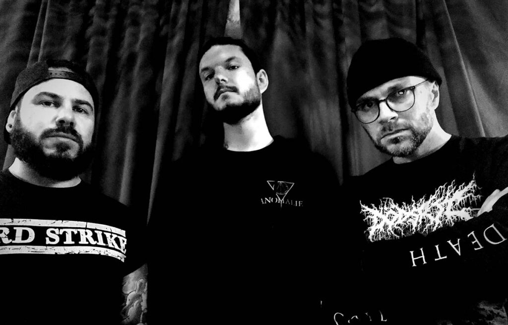 German blackened death/doom metal trio Greh premiere their brand new ...